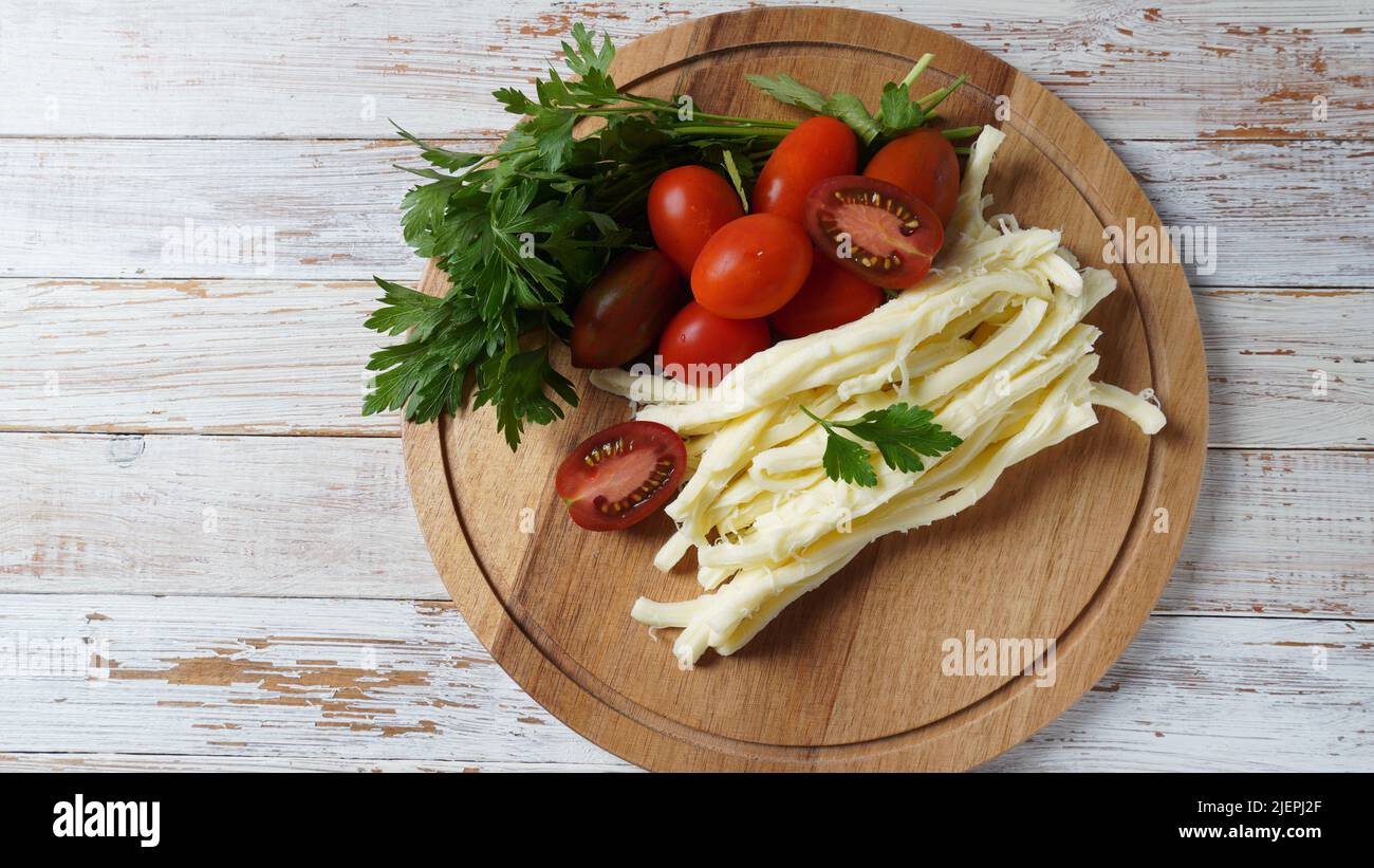 String cheese or cheese whip - salty snack cheese with cherry tomatoes ...