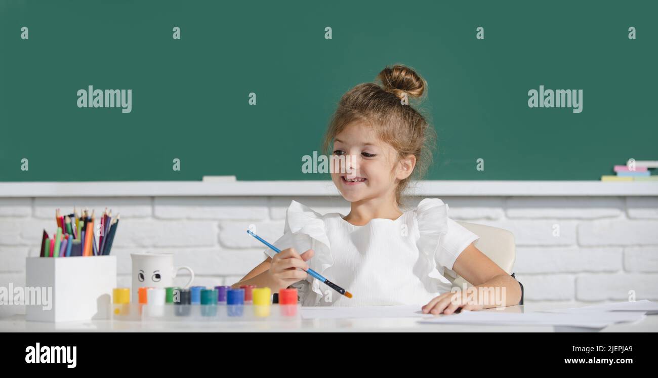 Child girl drawing with coloring pens paintind. Portrait of adorable ...