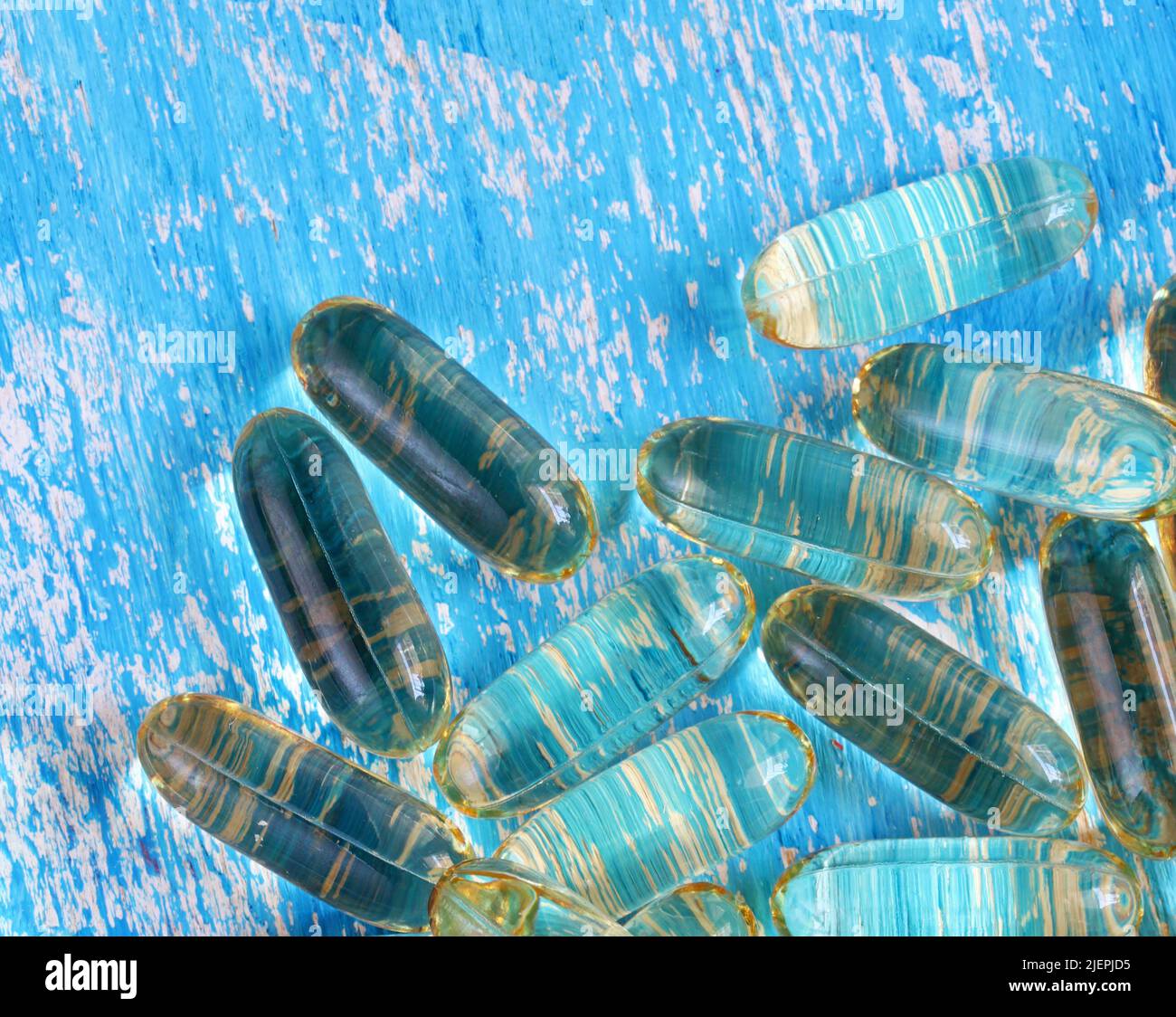 Transparent pills on blue background Stock Photo - Alamy