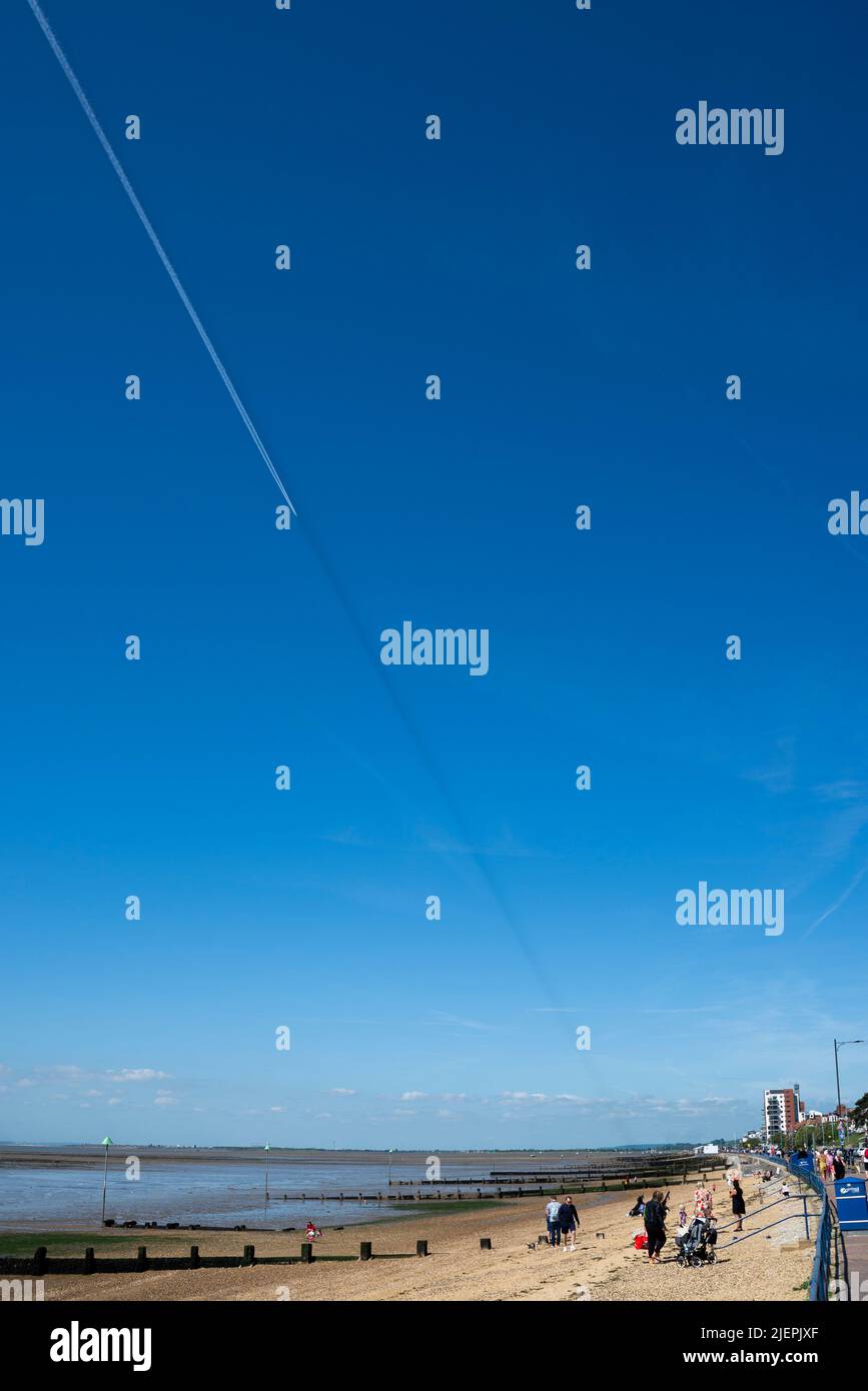 Contrails shadow. Jet airliner plane flying at altitude leaving ...