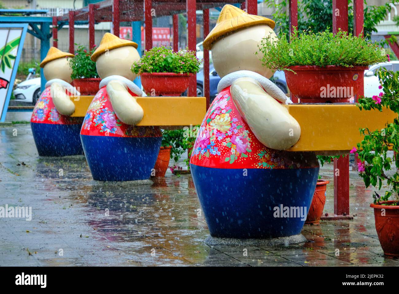 Park's farmer statues bringing pot Stock Photo - Alamy