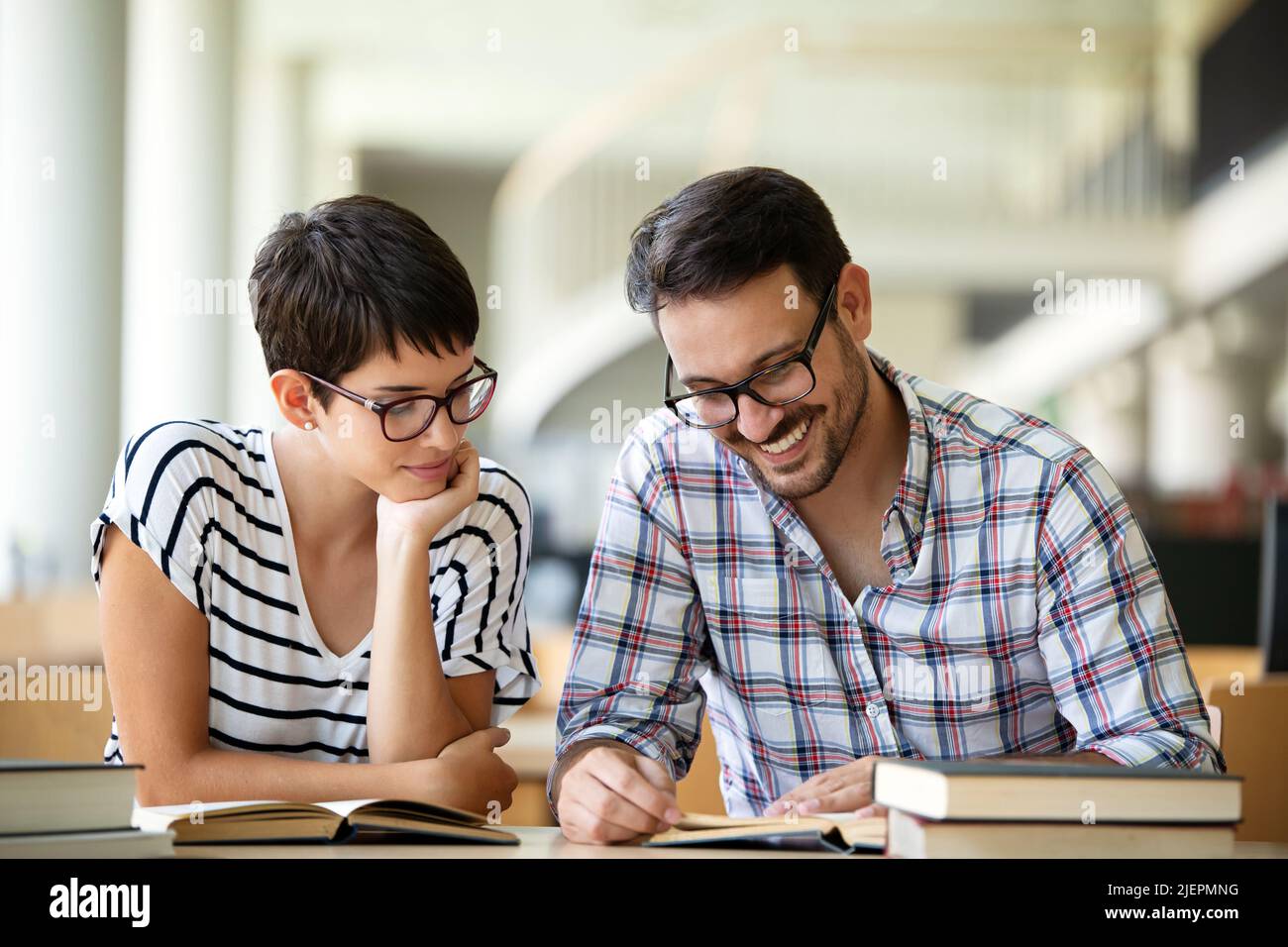 Students studying in library. Young success people are spending time ...