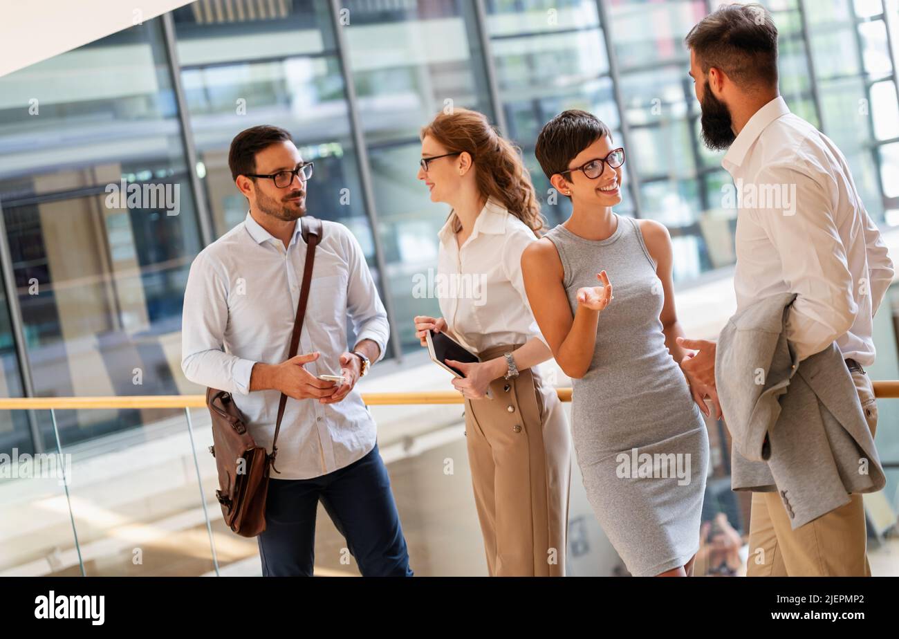 Business people having fun, teamwork and chatting at workplace office ...