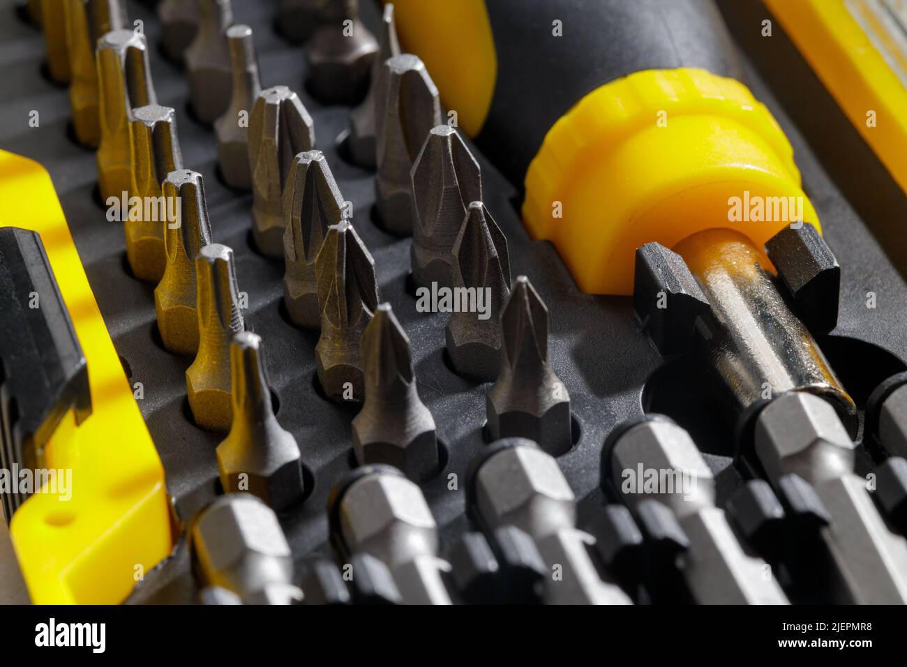 portable yellow screwdriver with bits. construction tool Stock Photo ...