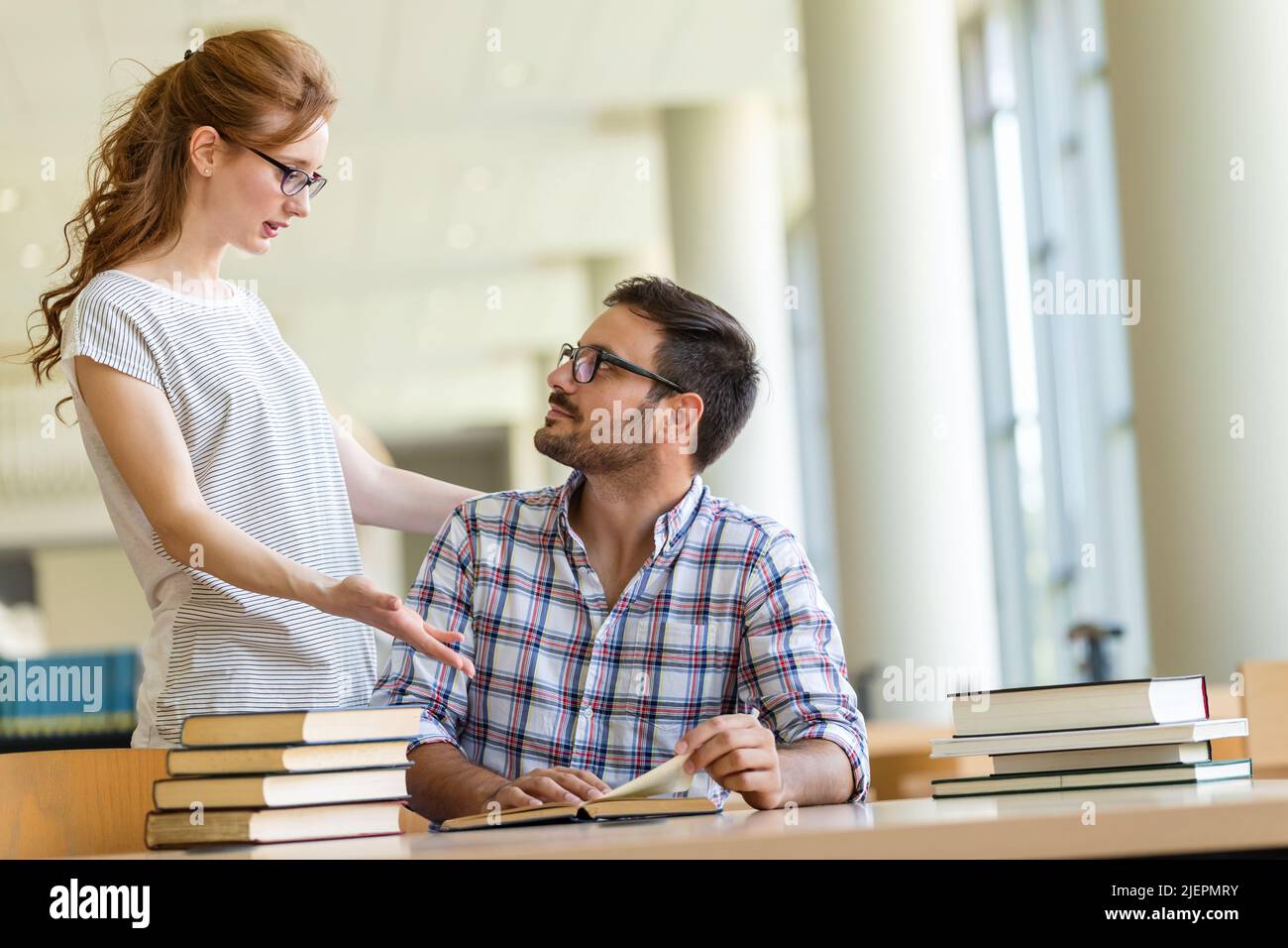 Happy group of students studying and working together in a college ...