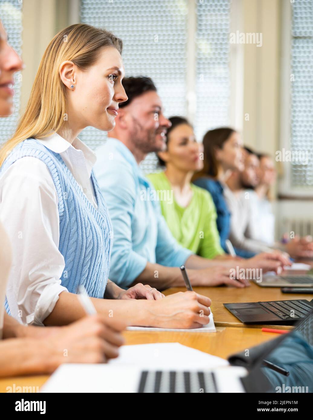 Small group of students attentively listening to lecture in university ...