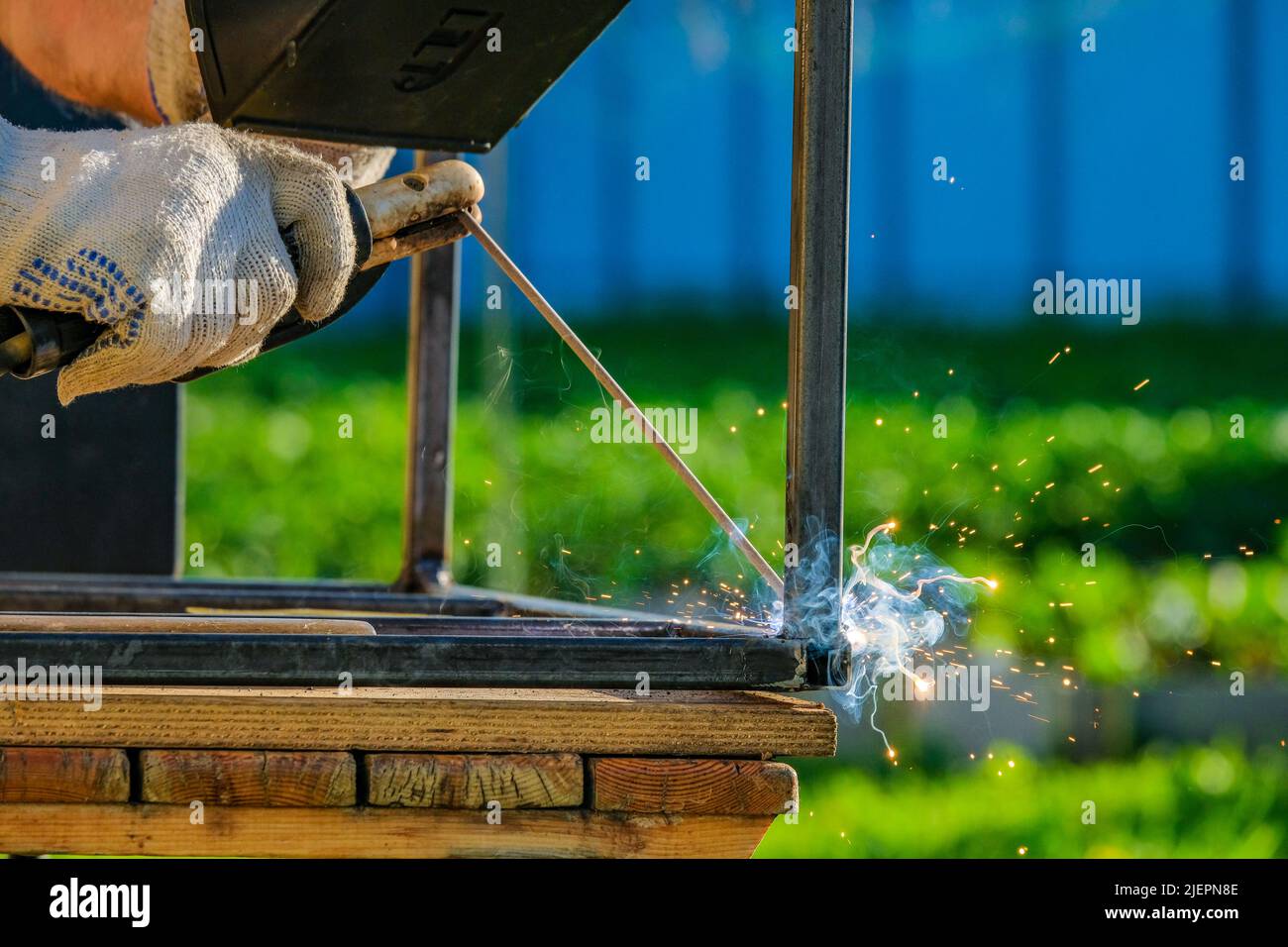 Drops of molten metal scatter when the metal is touched by an arc ...