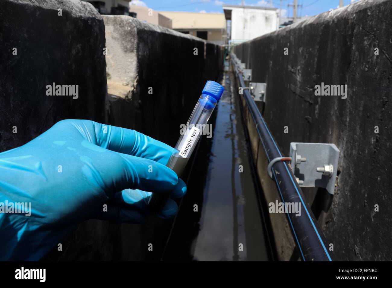 Collect samples of wastewater from industrial canals in test tubes to ...