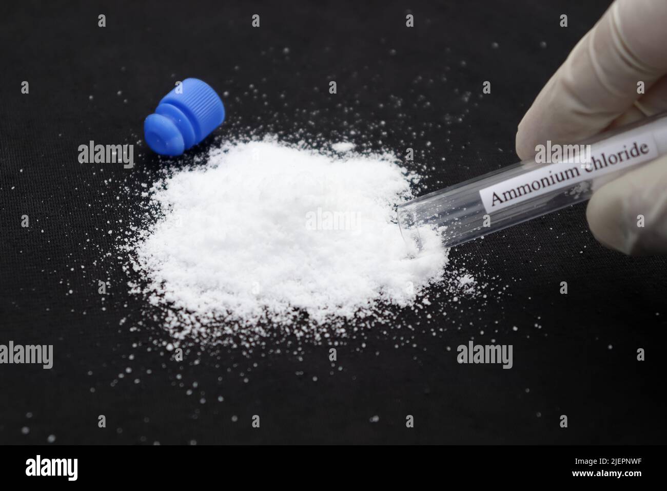 ammonium chloride in test tube and black background Stock Photo - Alamy