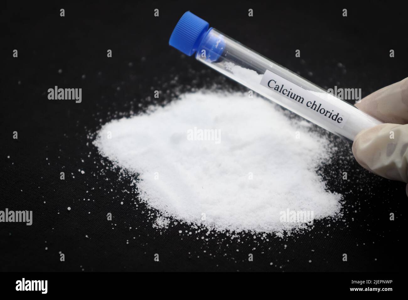 Calcium chloride in test tube and black background Stock Photo - Alamy