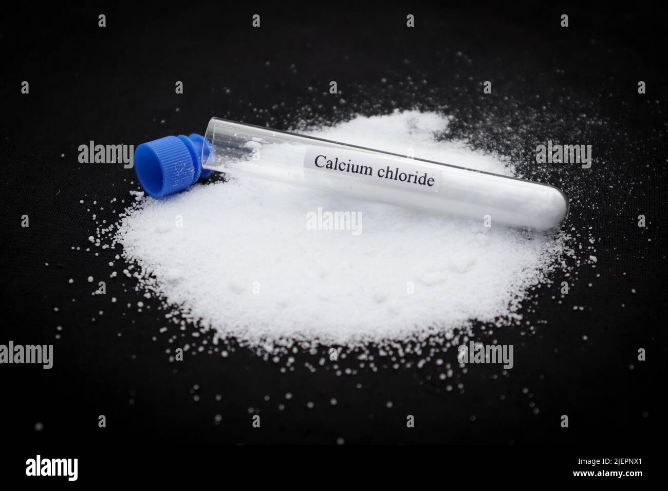 Calcium chloride in test tube and black background Stock Photo - Alamy