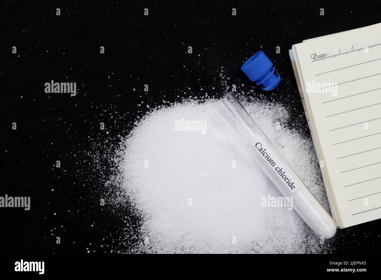 Calcium chloride in test tube and black background Stock Photo - Alamy