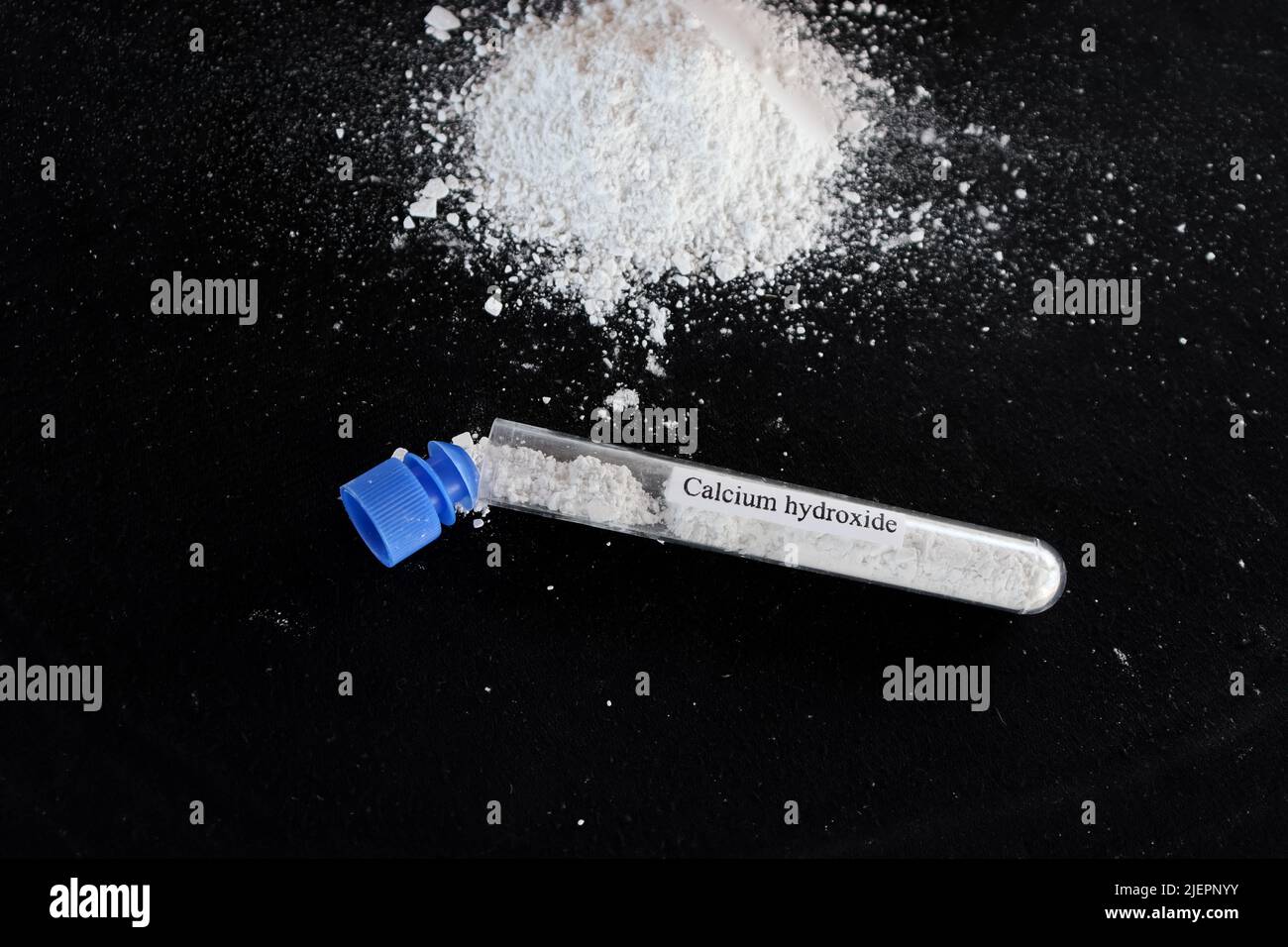 Calcium hydroxide in test tube and black background Stock Photo - Alamy