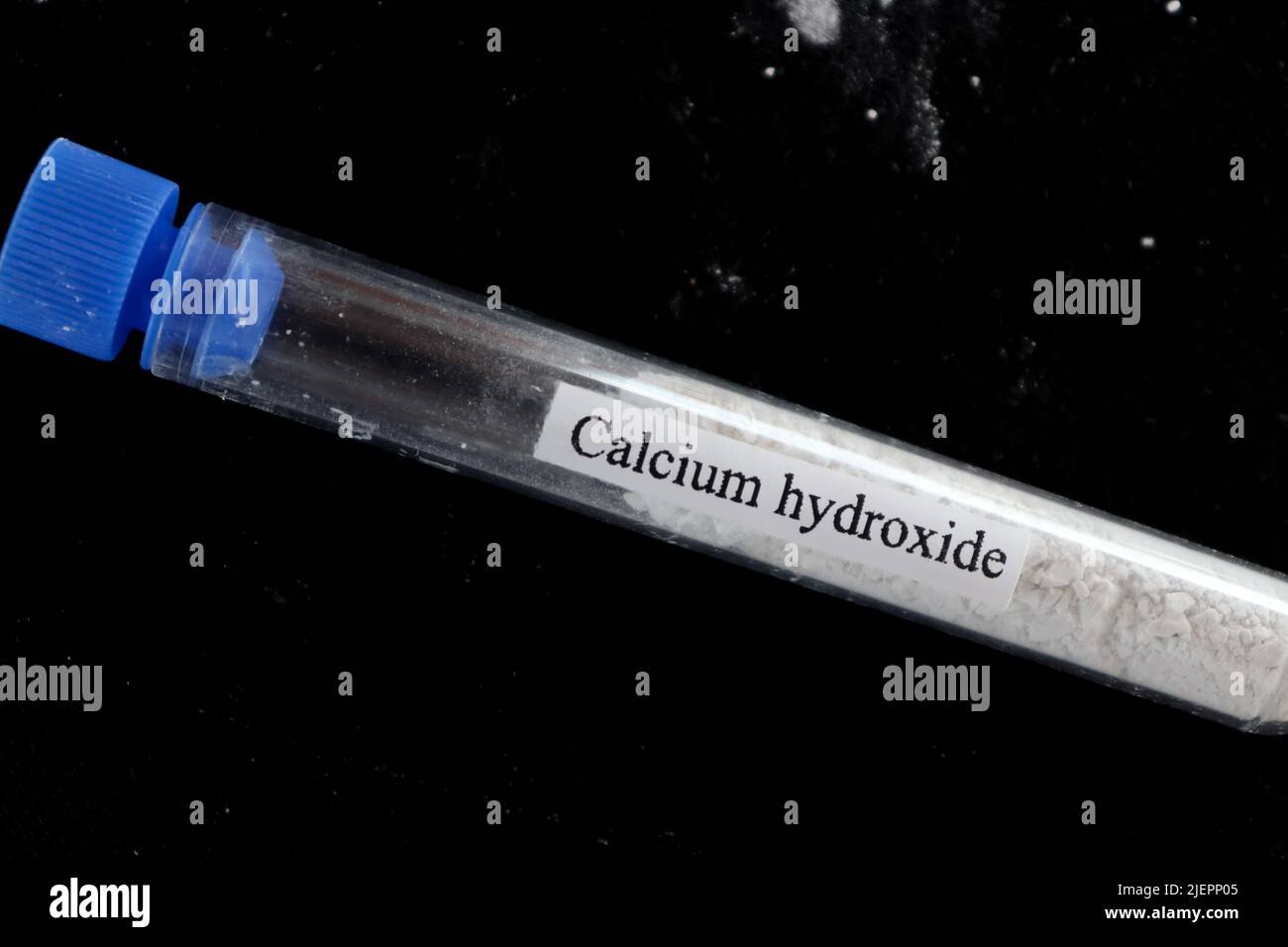 Calcium hydroxide in test tube and black background Stock Photo - Alamy