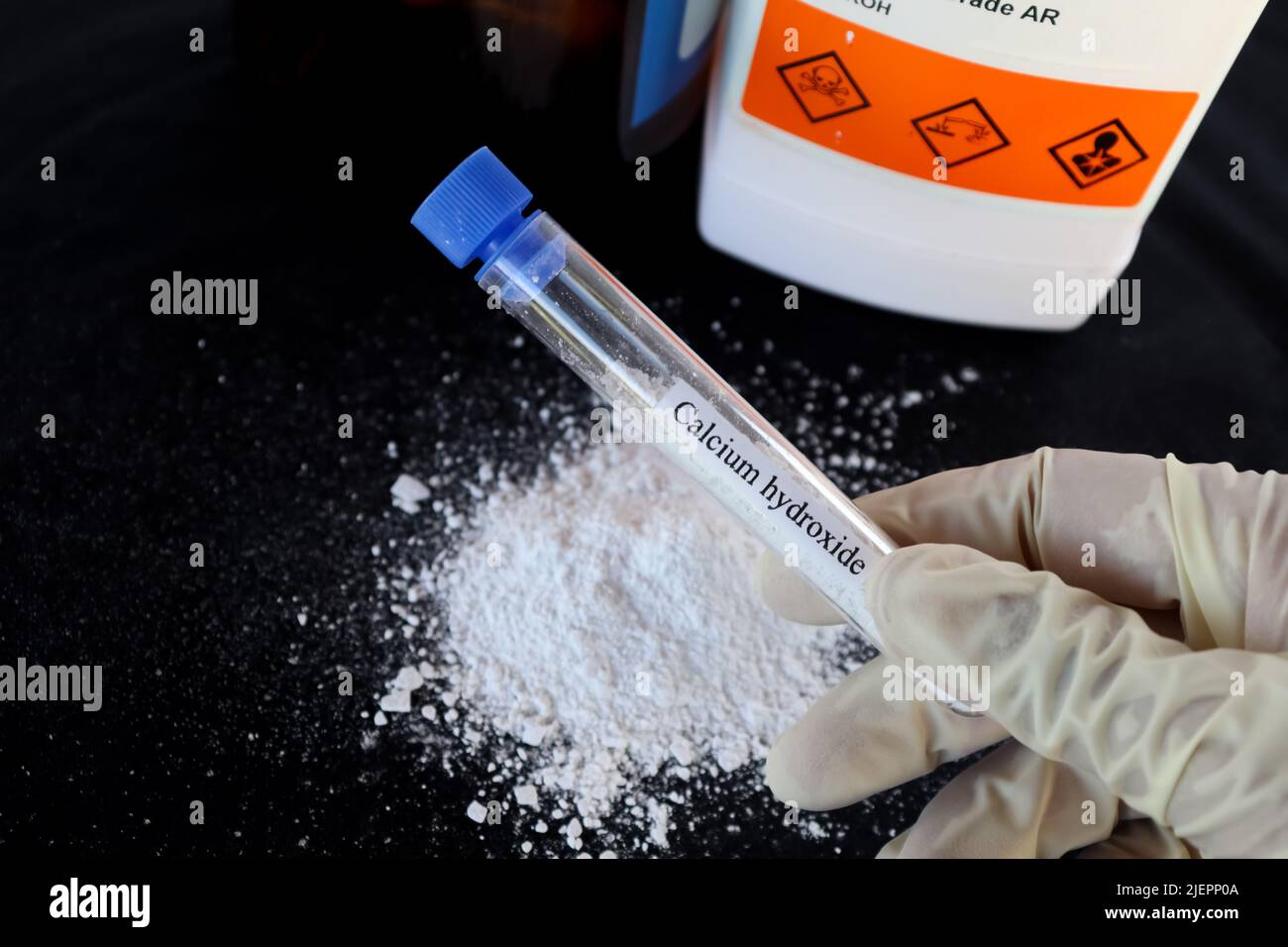 Calcium hydroxide in test tube and black background Stock Photo - Alamy