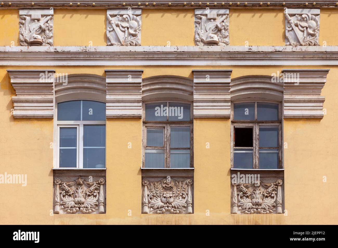 The windows of the old building decorated with stucco in the Soviet ...