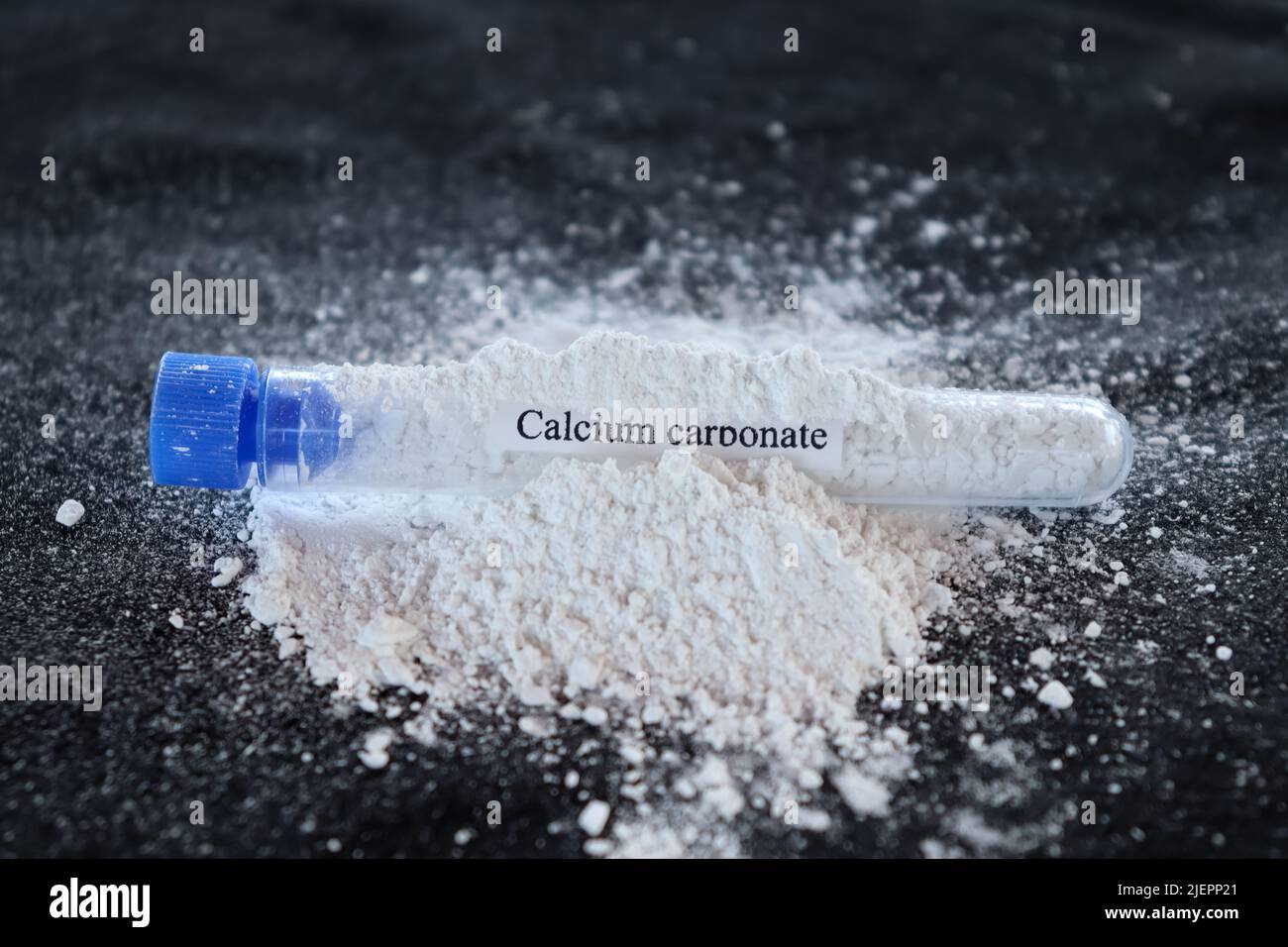 Calcium carbonate in test tube and black background Stock Photo - Alamy