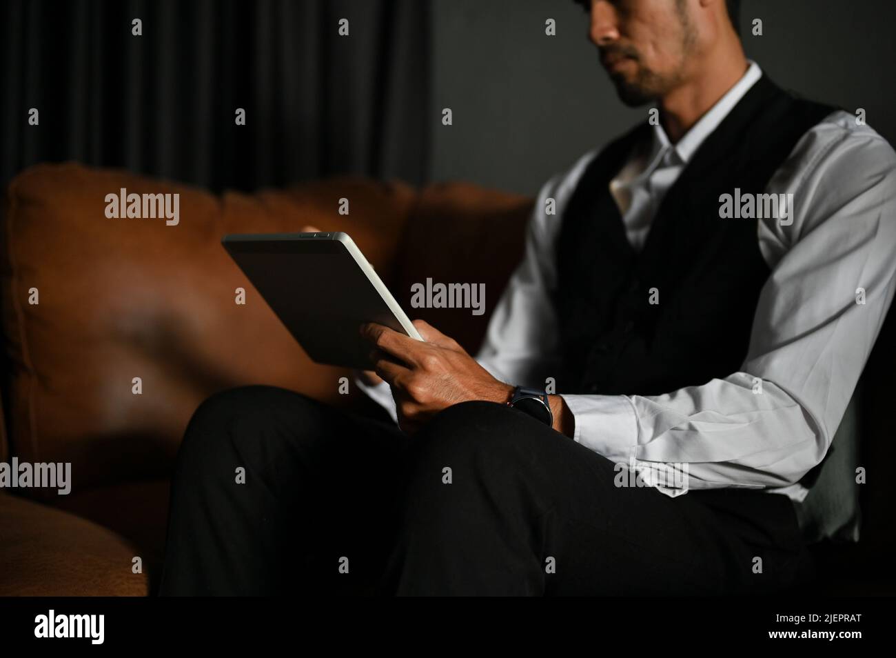 A professional Asian male executive manager or businessman sits at the ...