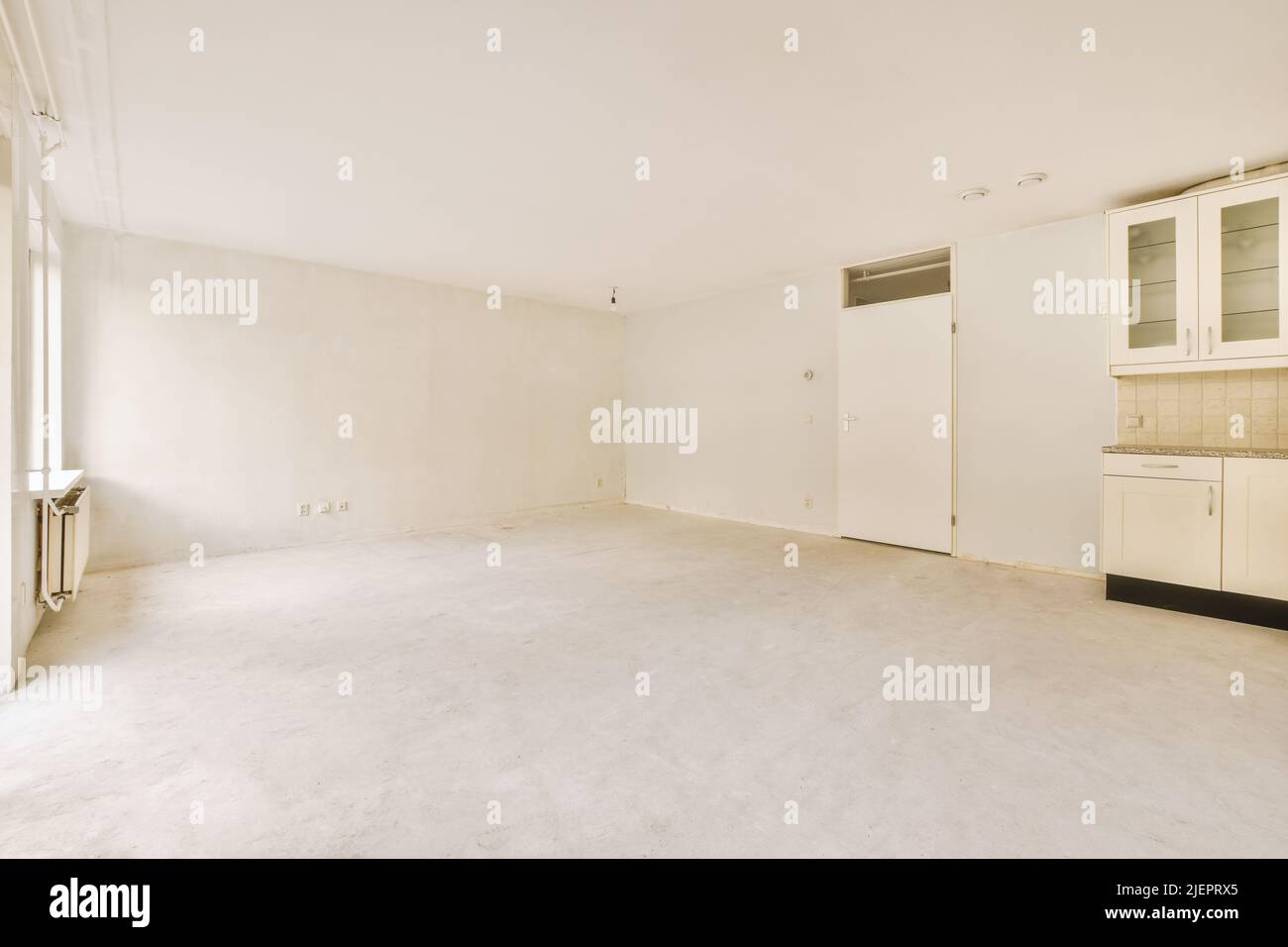 Interior of empty white kitchen with windows and wooden parquet floor ...