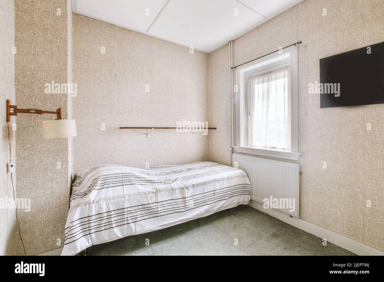 Comfortable bed with white bedclothes and bedside table with lamp ...