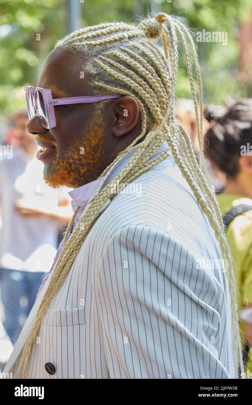 MILAN, ITALY - JUNE 19, 2022: Man with blond braids and purple ...