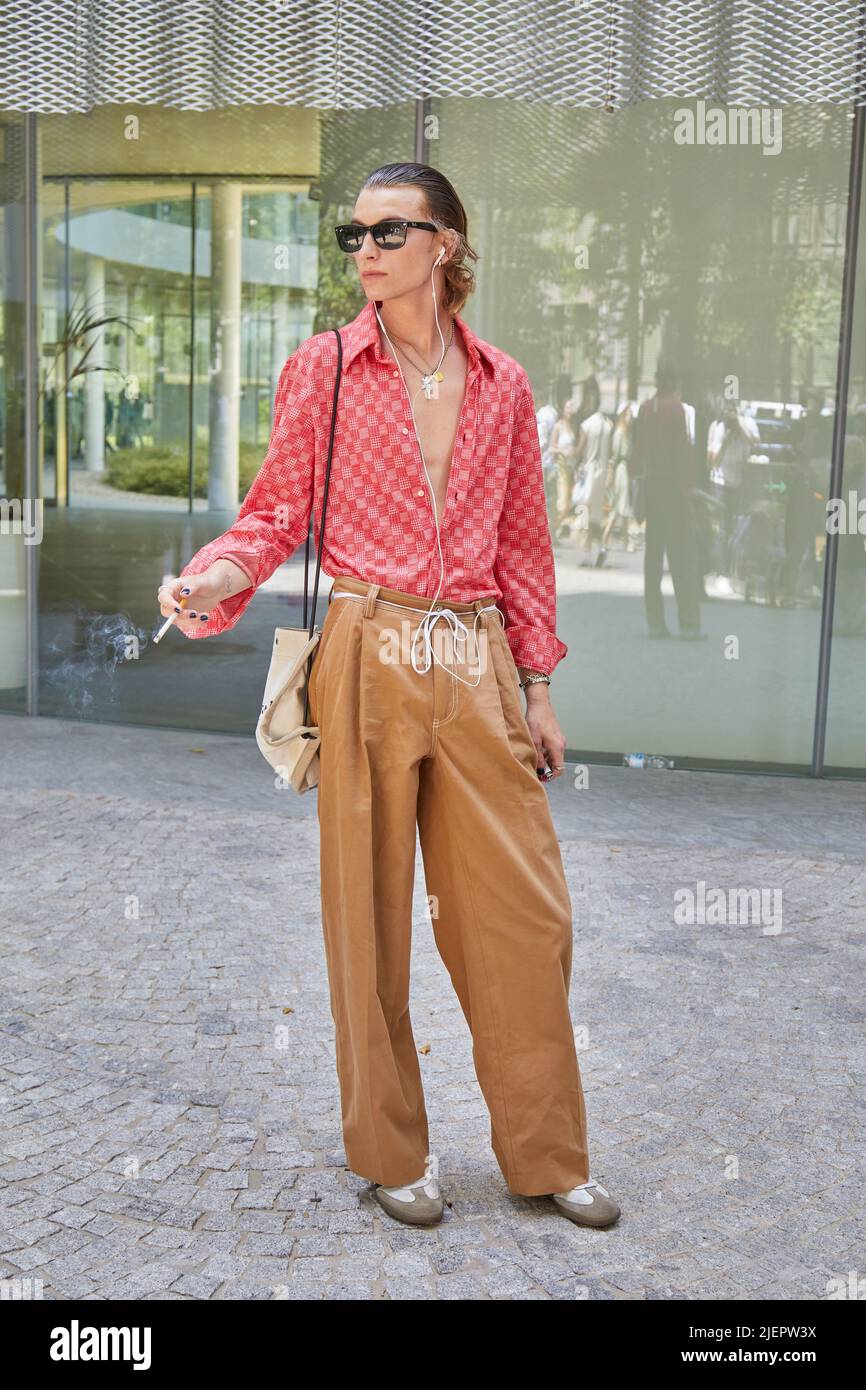 MILAN, ITALY - JUNE 19, 2022: Man with red open shirt and beige ...