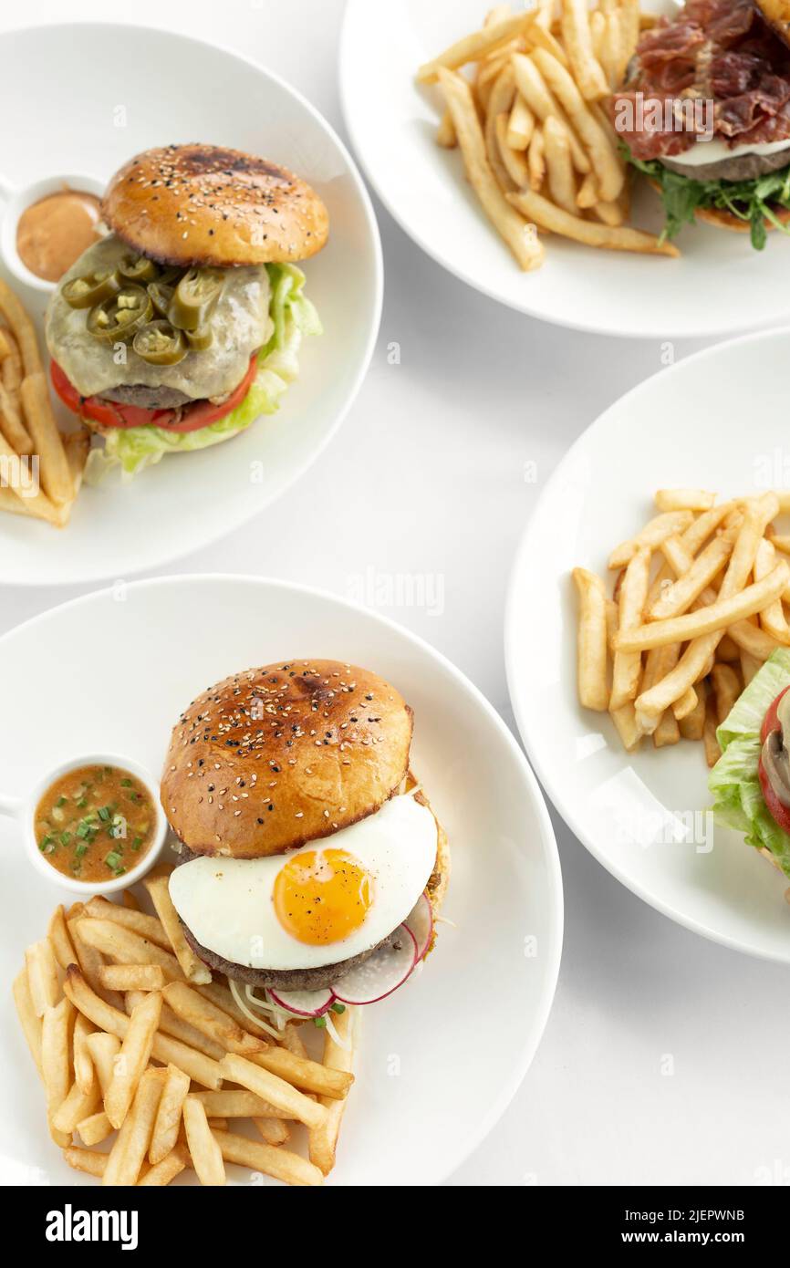 many different burgers on restaurant table Stock Photo - Alamy