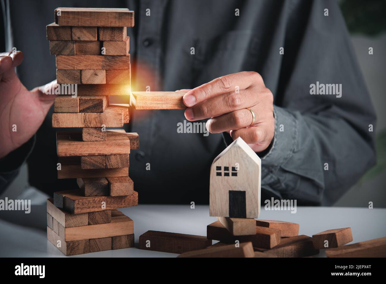 Alternative risk plan. Business hand playing tower wooden blocks game ...