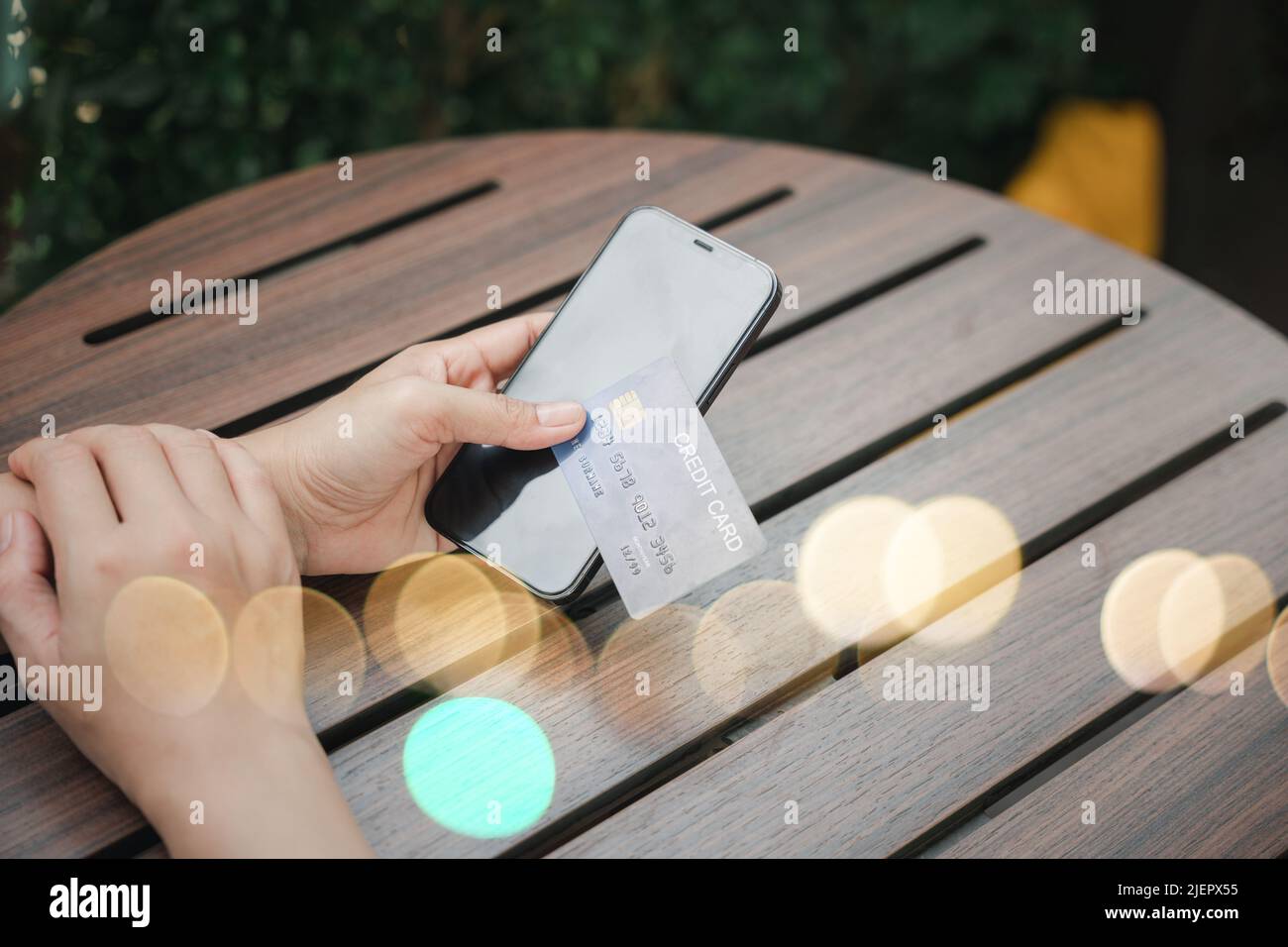 Close up hand of woman using credit card and smartphone during slide ...