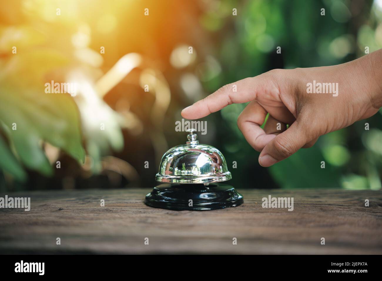 Hospitality hotel. Customer hand ringing service bell at coffee cafe ...