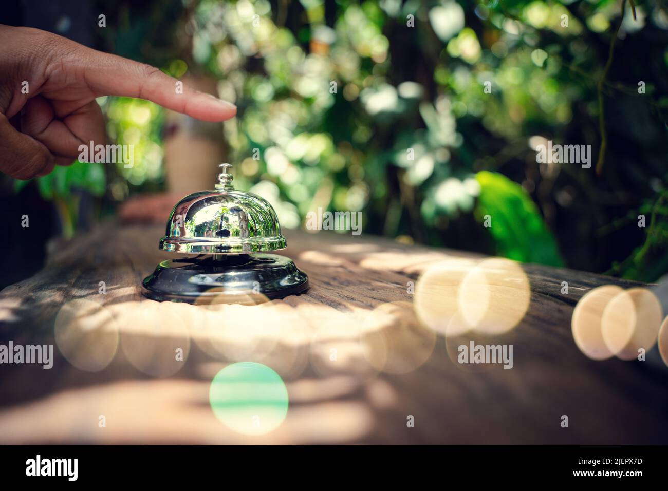 Hospitality hotel. Customer hand ringing service bell at coffee cafe ...