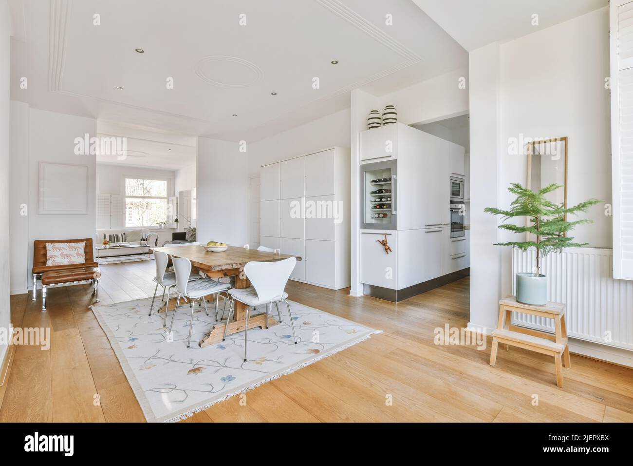 Comfortable couch located near carpet and table against window in ...