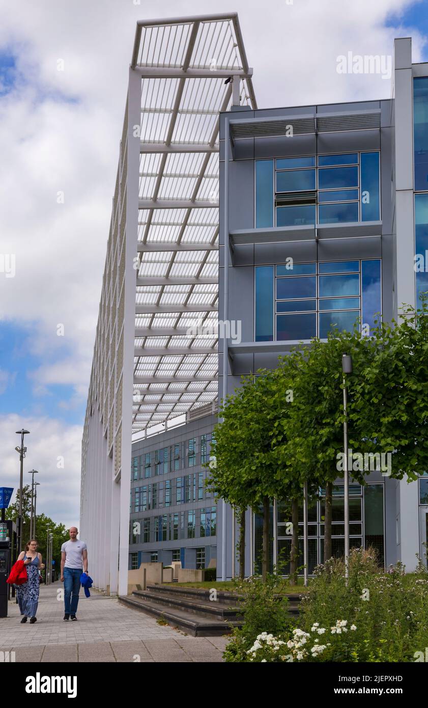 Couple walking past The Quadrant building at Milton Keynes ...