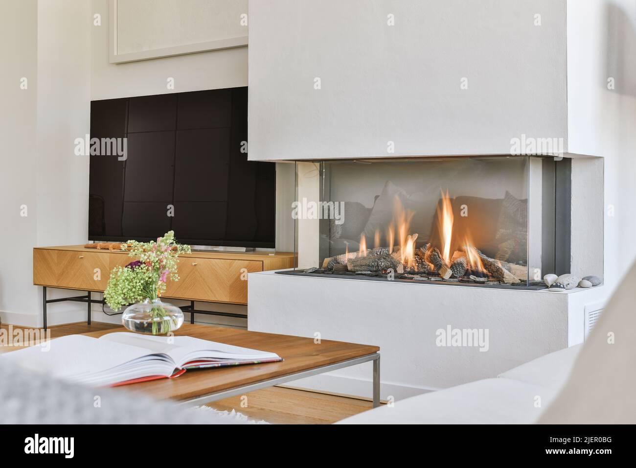 Comfortable couch located near carpet and table against window in ...