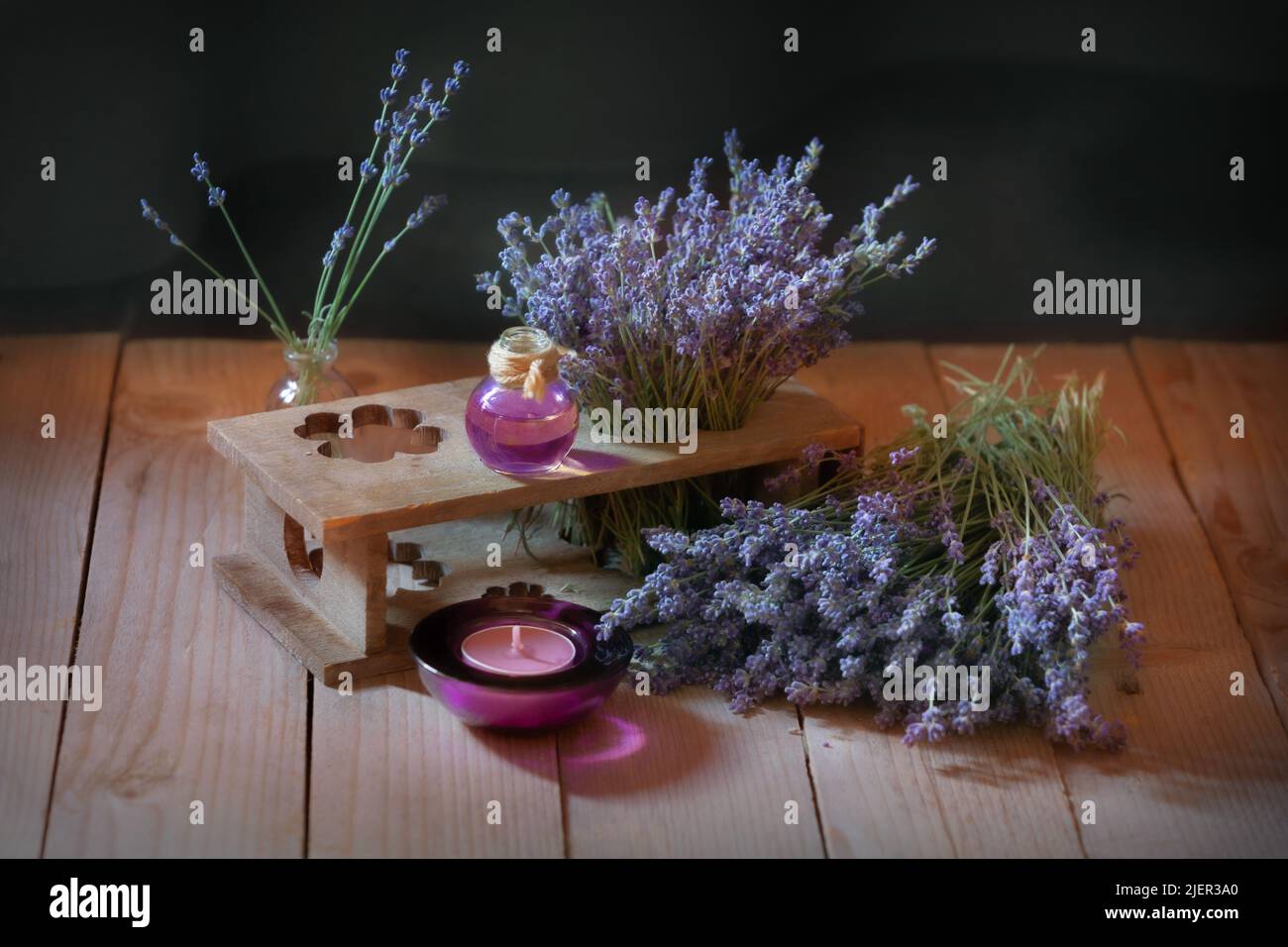 Herbal oil and lavender flowers still-life on wooden background Stock ...