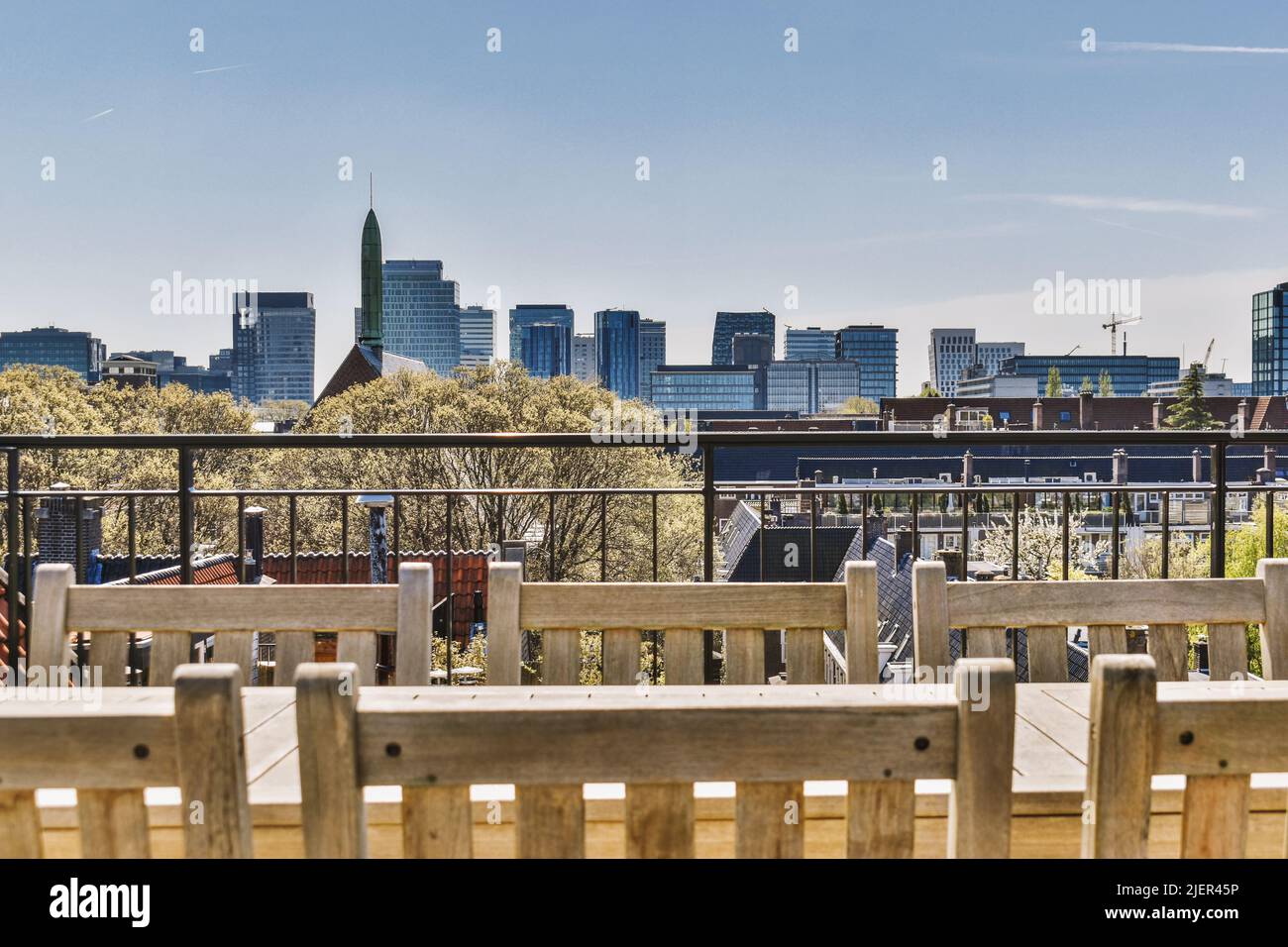 Front view of old brick buildings from small balcony with railings ...