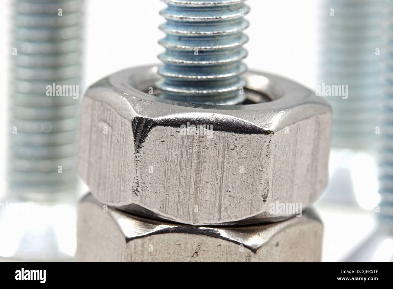 Close-up nuts and bolts isolated on white background Stock Photo - Alamy