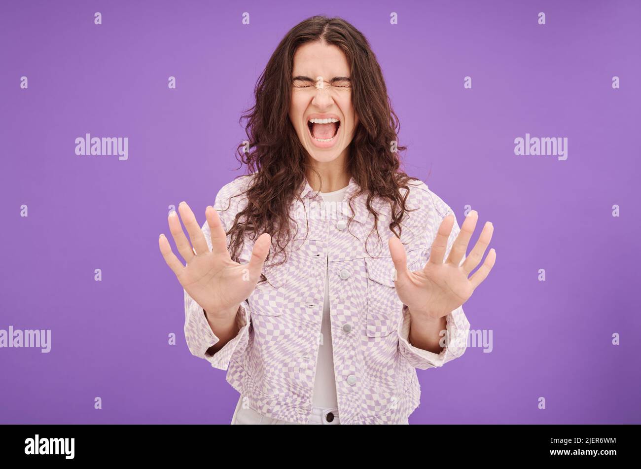 Portrait of young woman screaming with all her might to express ...
