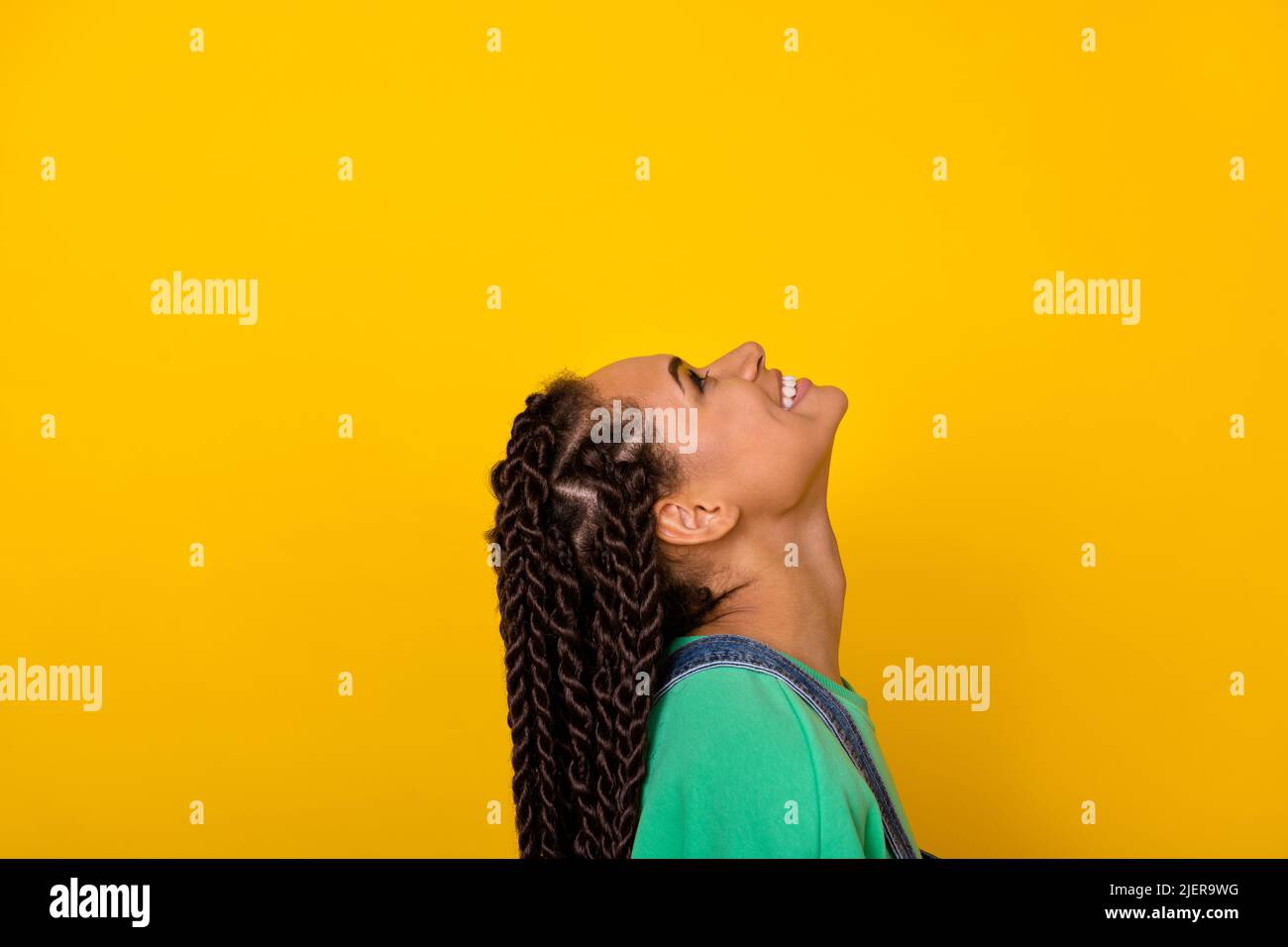 Profile portrait of cheerful pretty lady look interested up above empty ...