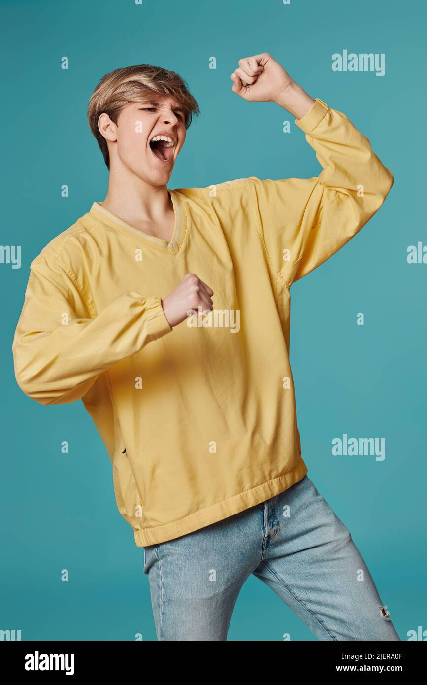 young man in casual yellow clothes dancing Stock Photo - Alamy