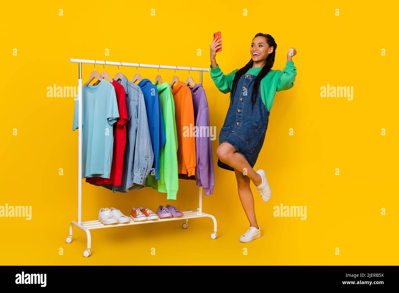 Full length portrait of delighted successful lady use telephone raise ...