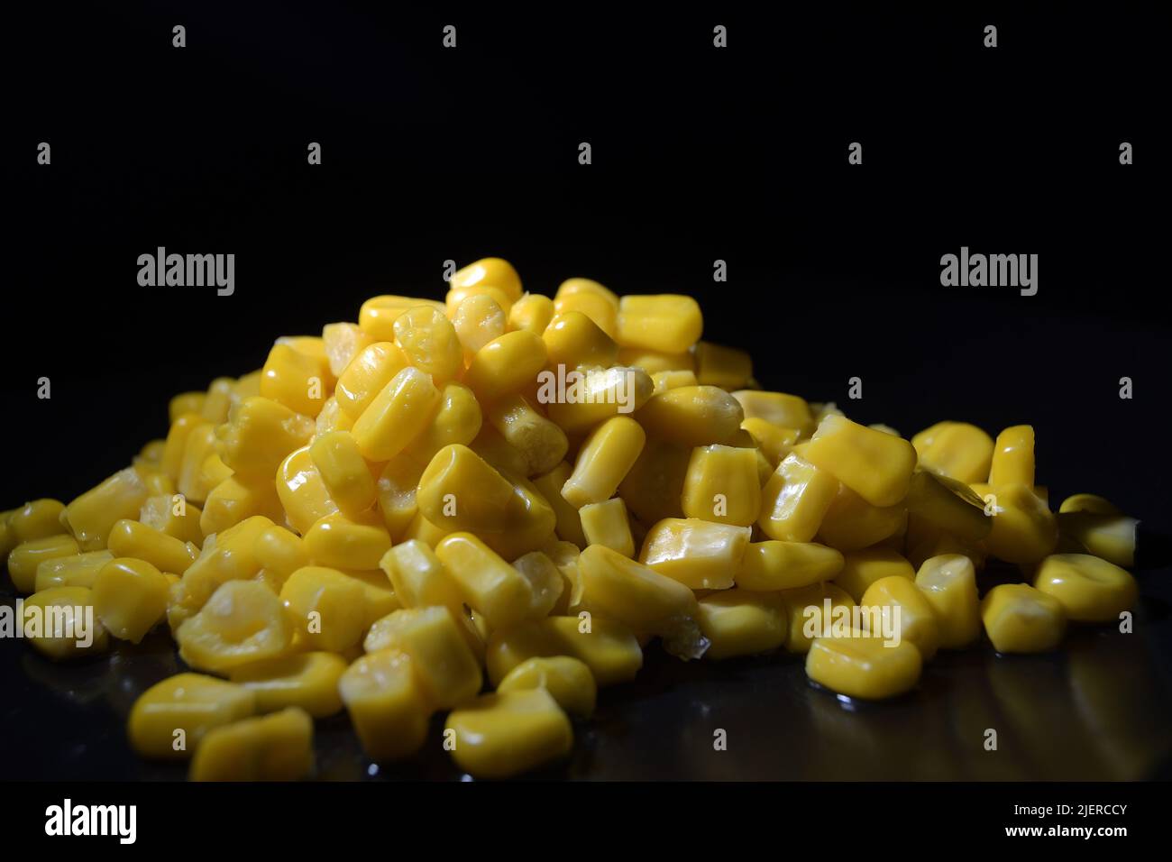 Mountain of boiled corn with black background Stock Photo - Alamy
