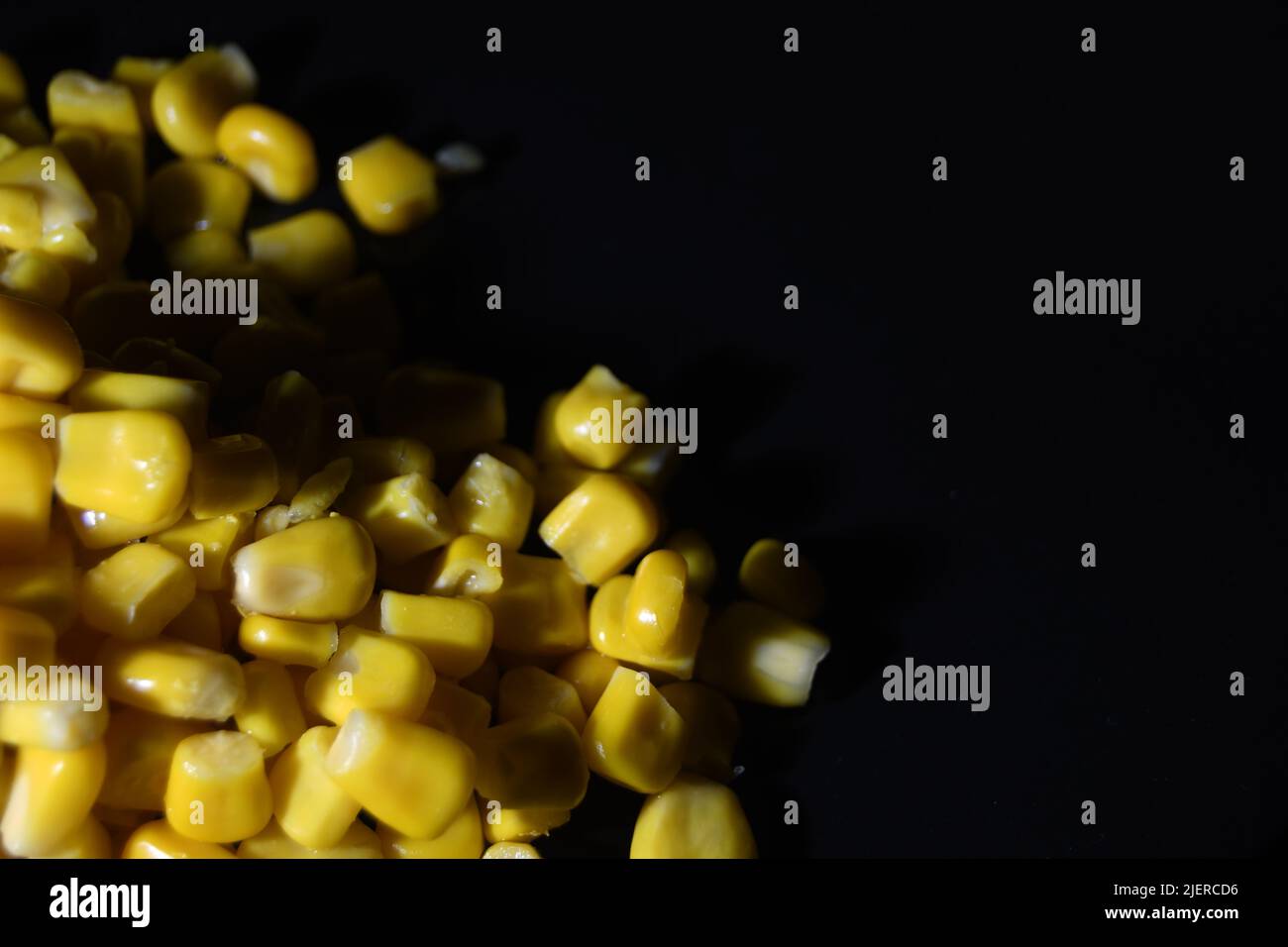 Mountain of boiled corn with black background Stock Photo - Alamy
