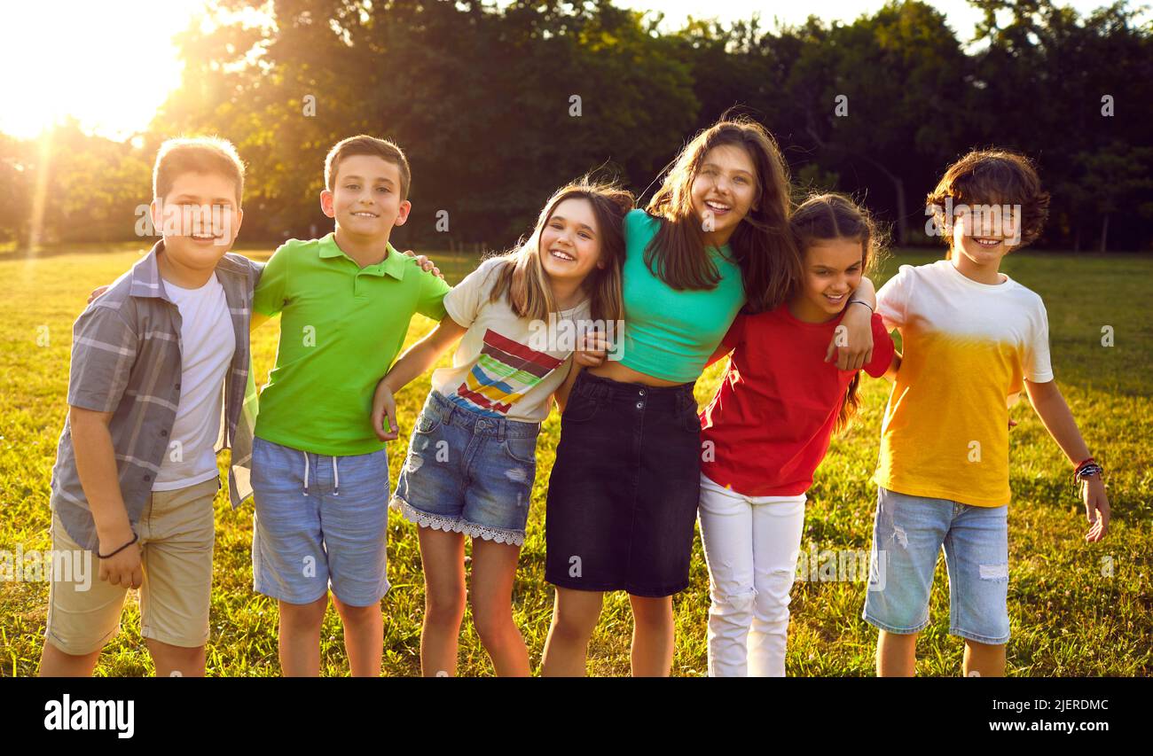 Happy joyful friends enjoying summer, playing in sunny park and having ...