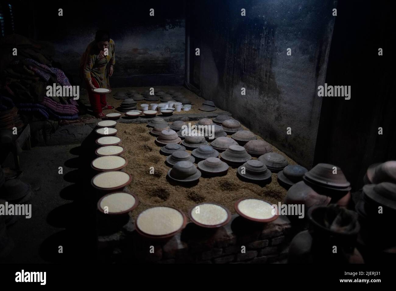 Bhaktapur, Nepal. 28th June, 2022. A woman prepares curd locally known ...