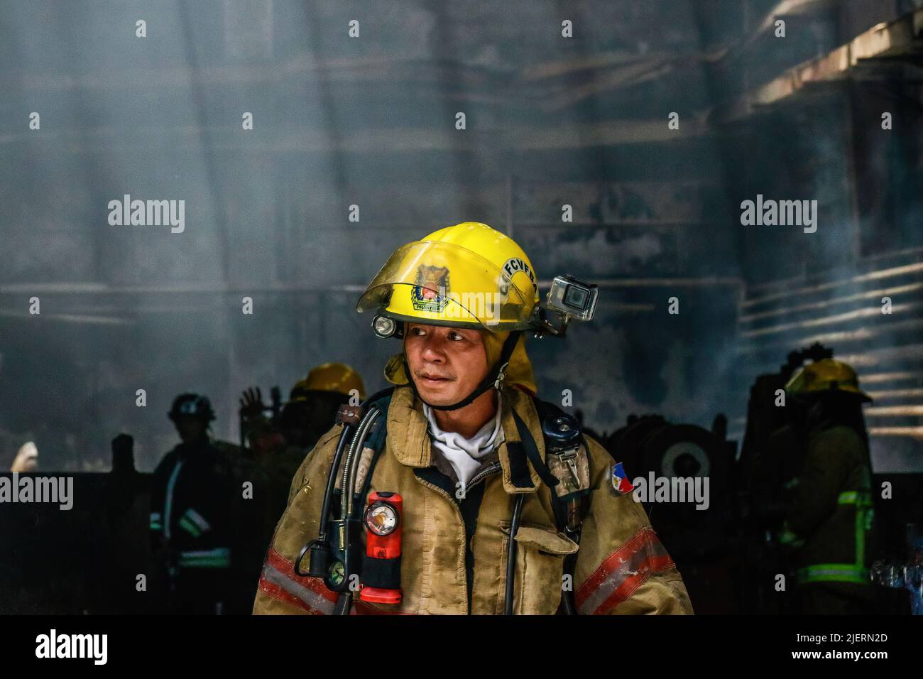 A firefighter exits the fire scene in Dela Paz. A fire broke out in a ...