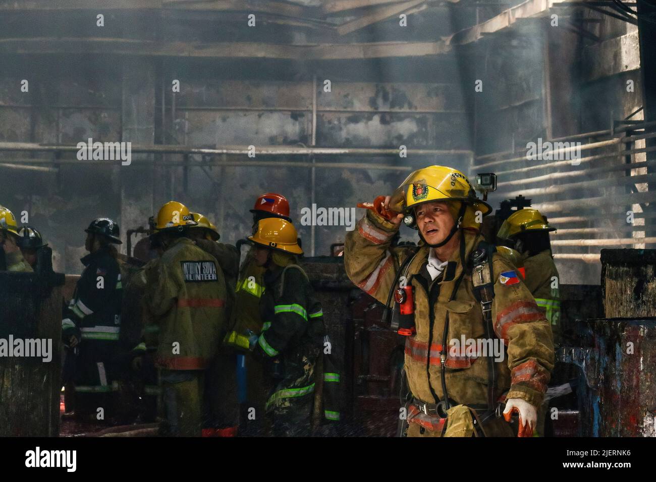 Pasig, Philippines. 28th June, 2022. A firefighter exits the fire scene ...