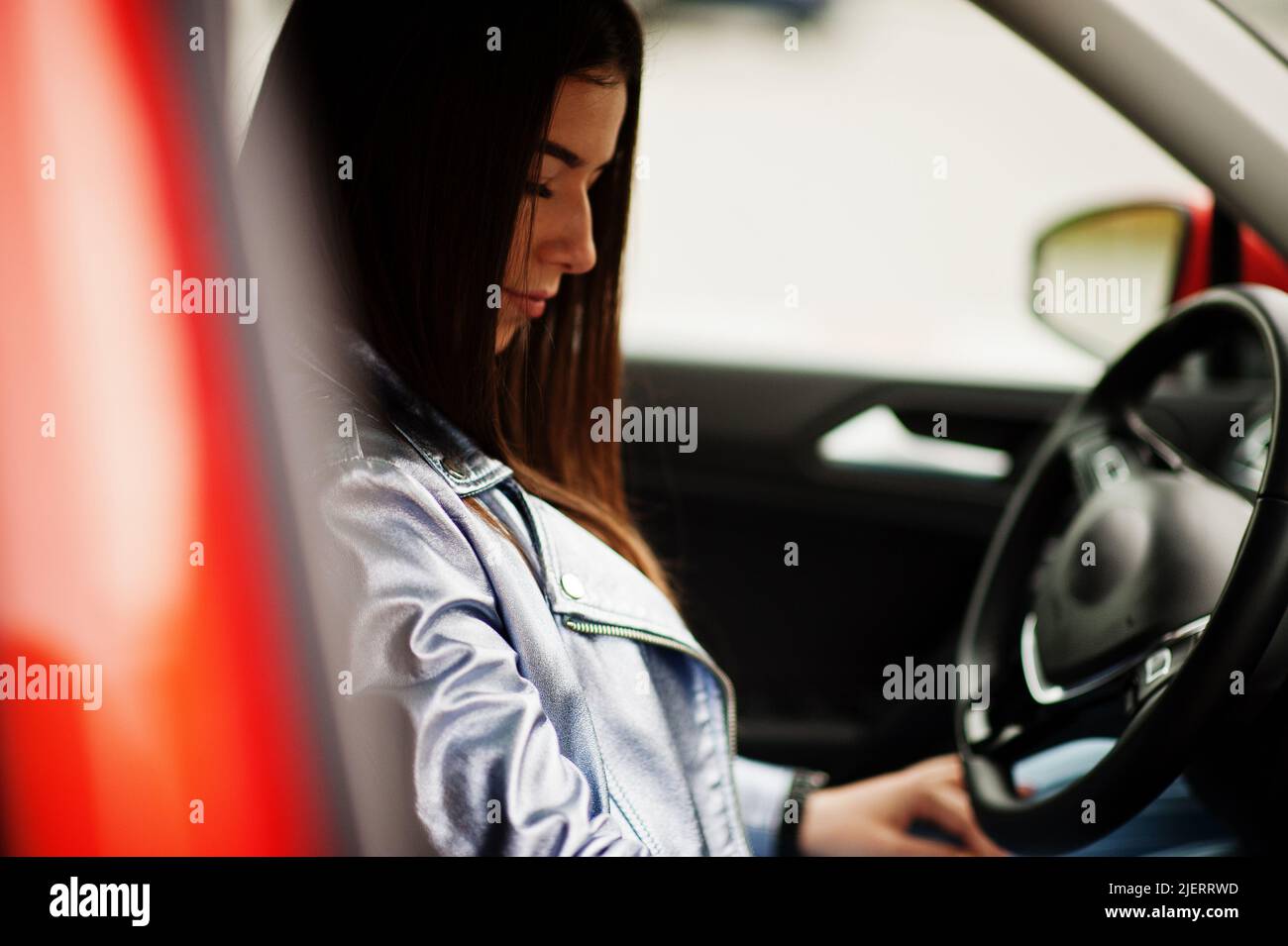 Gorgeous woman sitting inside car interior Stock Photo - Alamy