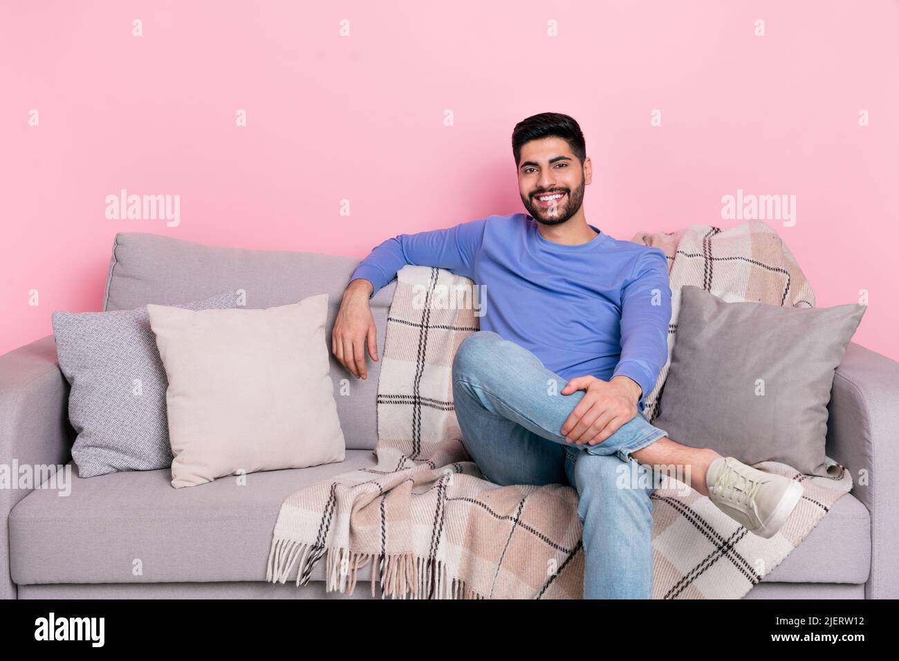 Photo of satisfied peaceful person sitting couch chilling toothy smile ...