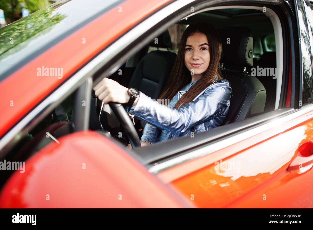 Gorgeous woman sitting inside car interior Stock Photo - Alamy